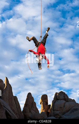 Climber in trouble at the end of his rope Stock Photo - Alamy