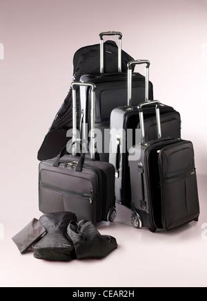 Studio shot of four suitcases with wheels isolated on white background ...