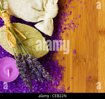 Bunch of dry lavender scented sea salt on wooden board healthcare ...