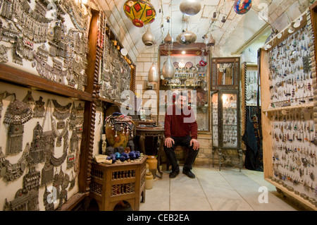 A shop owner at the Khan el Khal'ili Bazaar in Cairo, Egypt cleans one ...