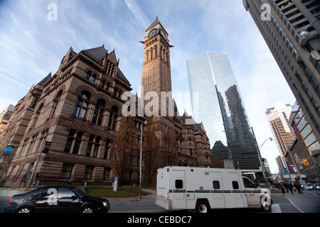 Old and new in Toronto. The Old City Hall mirrored on a modern glass ...
