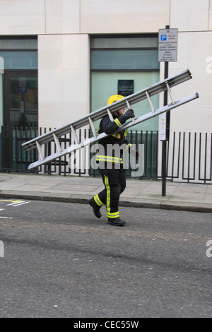 firefighters carrying a ladder Stock Photo - Alamy