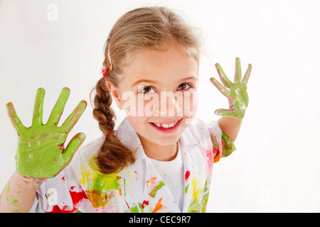 Messy Hispanic girl finger painting Stock Photo - Alamy
