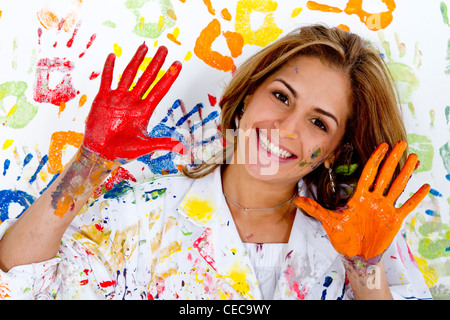 Messy Hispanic woman finger painting Stock Photo - Alamy