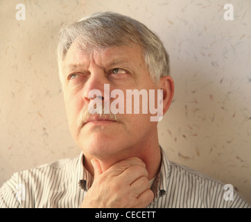 older man with a sore throat or neck Stock Photo - Alamy