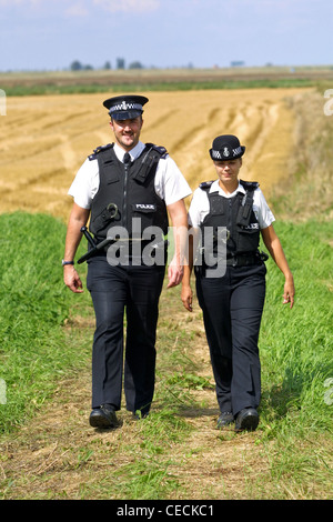 British Police officers patrolling rural area of Suffolk and talking to ...