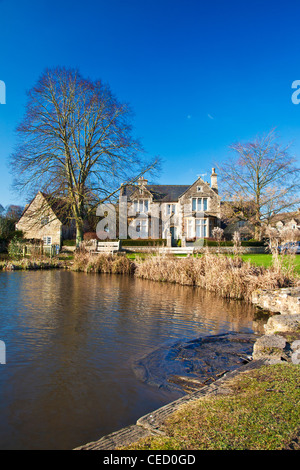 A typical English village duck pond on the green in Biddestone ...