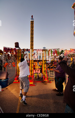 Carnival game of hit the bell Stock Photo - Alamy