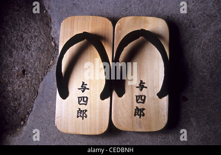 Pair of traditional geta (wooden sandals) sitting on a rock step at the ...