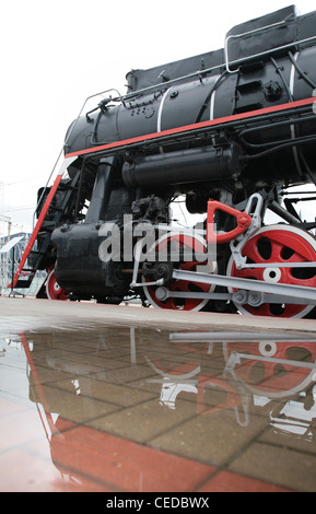 Reflection of train in a puddle Stock Photo - Alamy