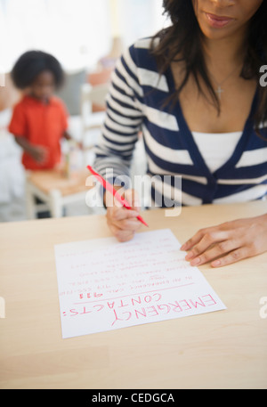 African American woman writing on a chalkboard in a modern office Stock ...