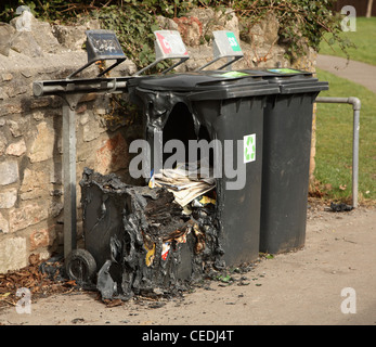 Burnt melted wheelie bin bins plastic arson vandal Stock Photo - Alamy