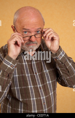 Elderly man with glasses and questioning look Stock Photo - Alamy