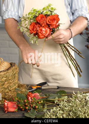 Florist tying bouquet in shop Stock Photo - Alamy