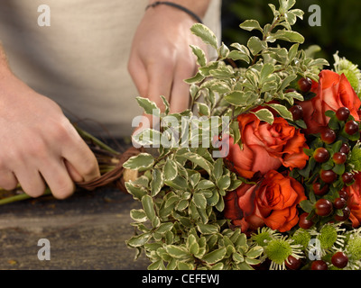Midsection of man preparing rope for work in forest Stock Photo - Alamy