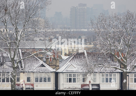 Snow covered rooftops of south London residential houses, some with ...
