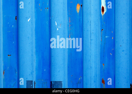 Corrugated metal surface of a shipping container with white painted ...