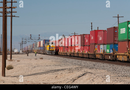 Railway freight train carrying containers rail lines rear view Stock Photo - Alamy