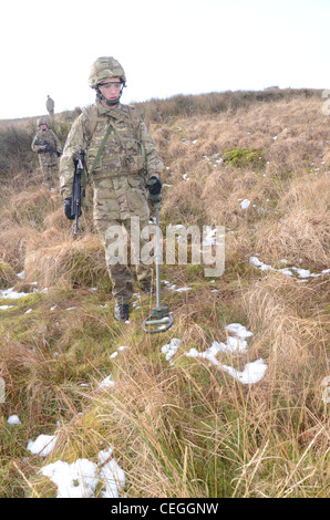 A British army solder 'Vallon man' looking for IED's using a Vallon ...