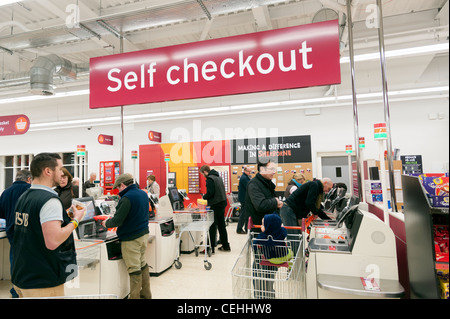 people using Self Service checkouts, WH Smith, Gatwick airport, UK ...