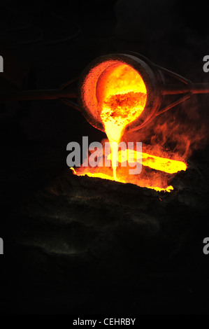 Pouring Molten Gold into a bar mold, inside of the smelter of the Round ...