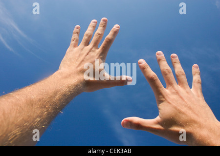 A male hand stretching to reach the sky Stock Photo - Alamy