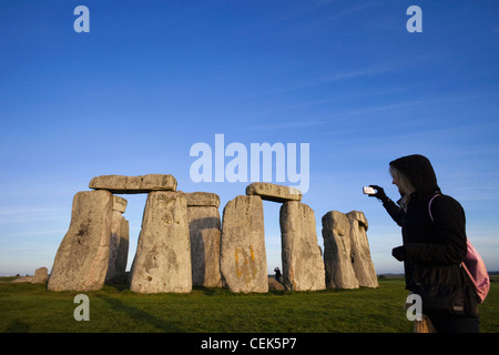 England, Wiltshire, Stonehenge, Tourists posing for photographs at ...
