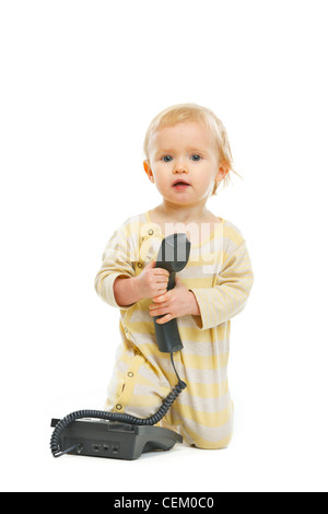 Adorable caucasian girl playing with telephone toy sitting on floor at ...
