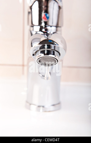 Modern faucet closeup with cute water drop Stock Photo - Alamy