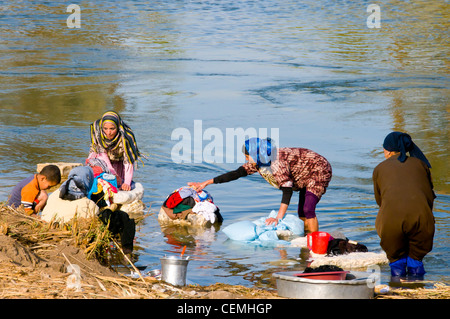 Rural scene - People washing clothes on river bank Stock Photo - Alamy