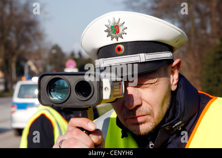 Police officer with a laser gun for speed monitoring, Berlin, Germany ...