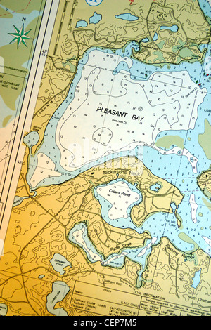 Navigation with nautical charts in the chart room on a sailing yacht ...