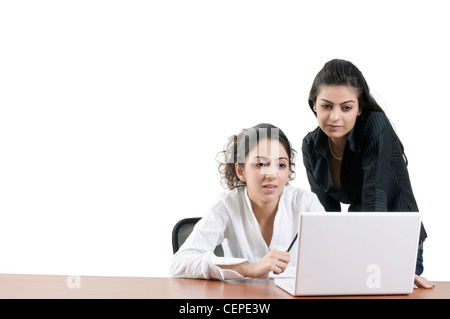 Two serious businesswomen girls discussing a business project, working ...