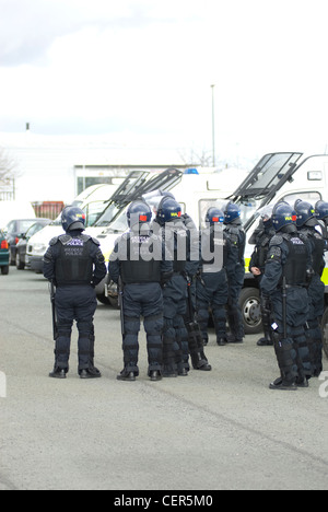 Uk riot police at the scene of a civil disturbance dressed in riot gear ...