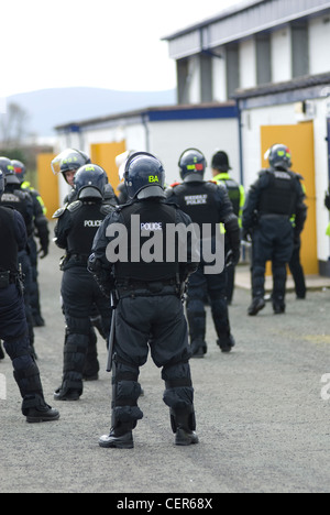 Uk riot police at the scene of a civil disturbance dressed in riot gear ...