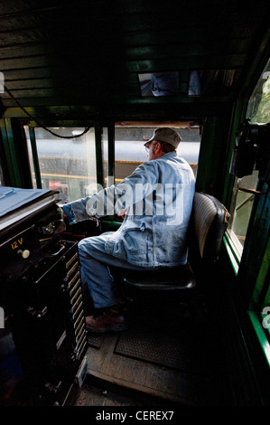 A train engineer driving an antique diesel locomotive on the Lake ...