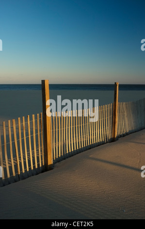 A windbreak fence on the beach at sunset in Ocean City Maryland, USA ...