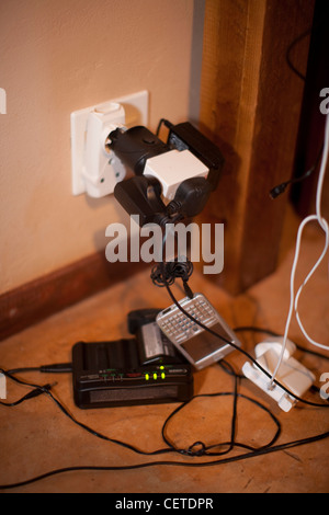Overloaded electrical power socket. Power sockets containing a plug ...