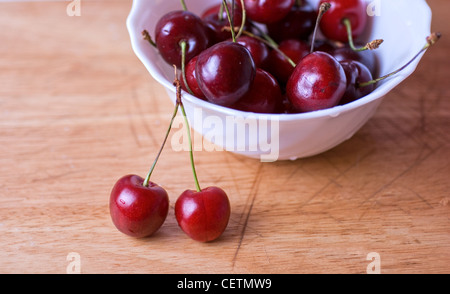 Set of rich, healthy red cherries on a wooden table in a cherry orchard ...