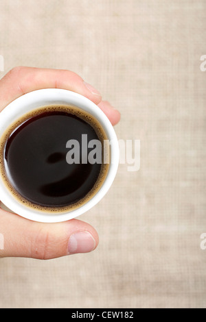 Cup of coffee in hand on the background of a beautiful beach Stock ...