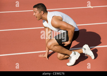 Runner injured while running on track Stock Photo - Alamy