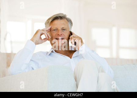 Senior sitting and talking on the phone Stock Photo - Alamy