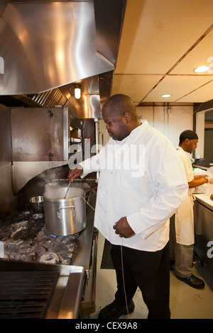Chef cooking in kitchen Stock Photo - Alamy