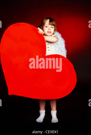 KId angel with heart symbol love and valentines day. Beautiful little ...