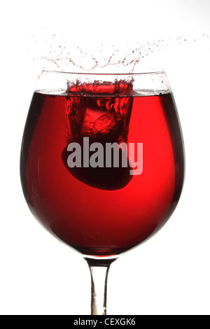 A full glass of red wine spilling over Stock Photo - Alamy