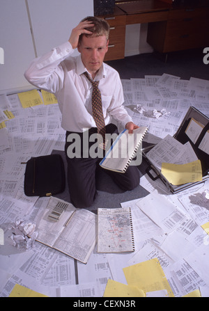 Office Environment - Frustrated overworked office worker at her desk ...