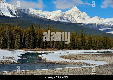 Snow-capped mountains with rocky terrain and icy lake Stock Photo - Alamy
