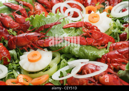 Close-up of cooked lobster in black bowl with chili peppers, lemongrass ...