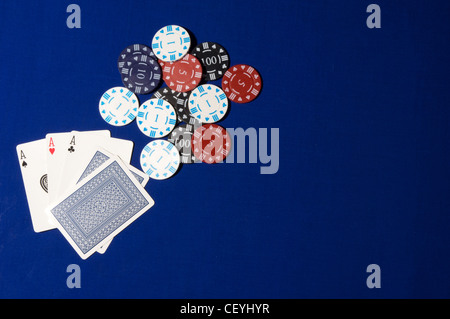 Poker hand layed out on blue background with two hidden cards and chips ...