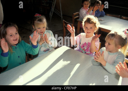 nursery school girls clapping and singing in class Stock Photo - Alamy
